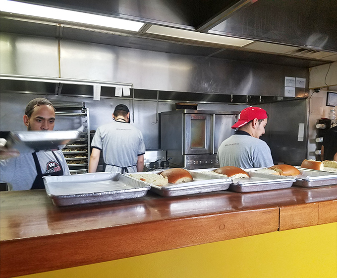 Behind the scenes where the magic happens. The kitchen crew moves with the precision of a barbecue ballet.