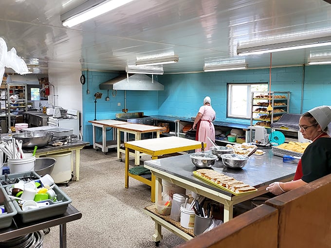 The kitchen where magic happens daily. Those aren't just bakers – they're artists whose canvas happens to be flour, sugar, and butter.