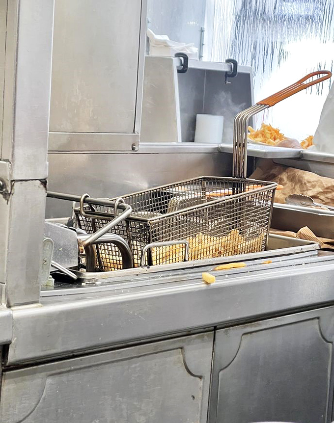 The fryer basket holds golden treasures that would make Fort Knox envious of their crispy perfection.