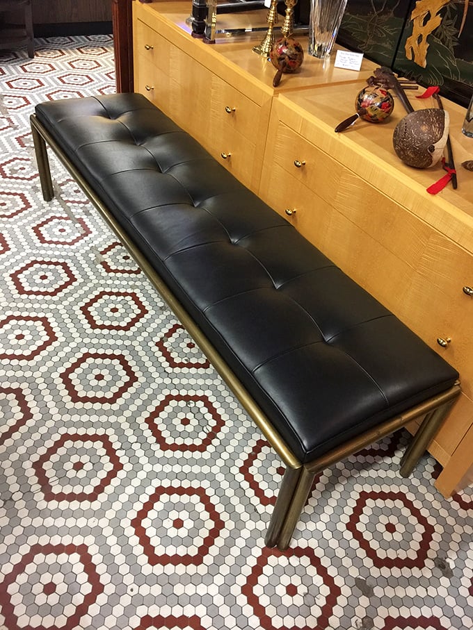 This tufted leather bench with brass frame isn't just seating—it's a statement piece that whispers "I have excellent taste" to your guests.