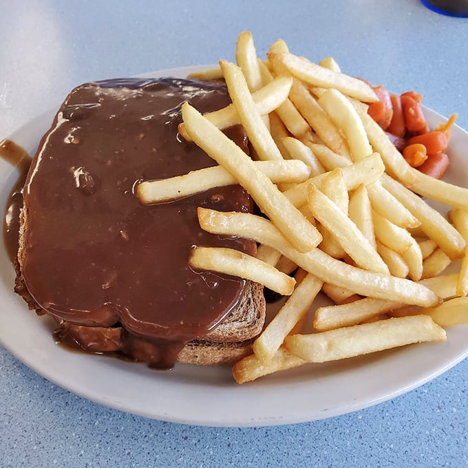 A hot open-faced sandwich smothered in gravy—comfort food that hugs you from the inside. The kind of meal that makes you want to take a nap afterward, but in the best way.