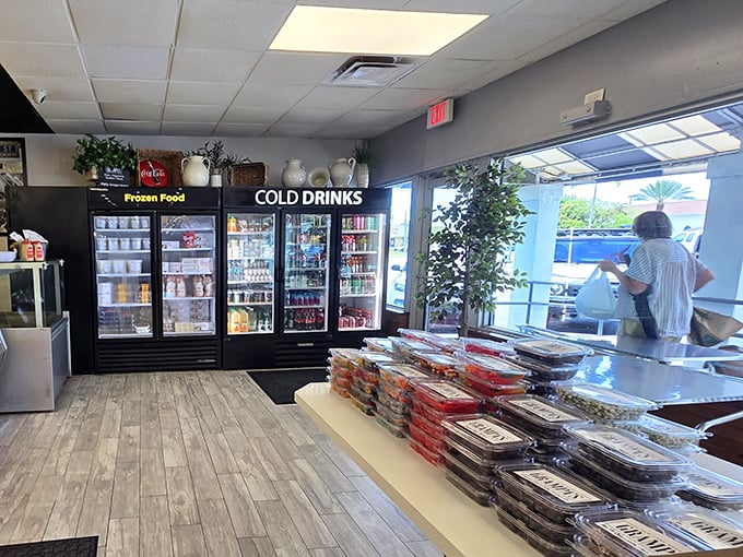 The refrigerated section stands ready with cold drinks and take-home treasures. Tomorrow's lunch is just a purchase away.