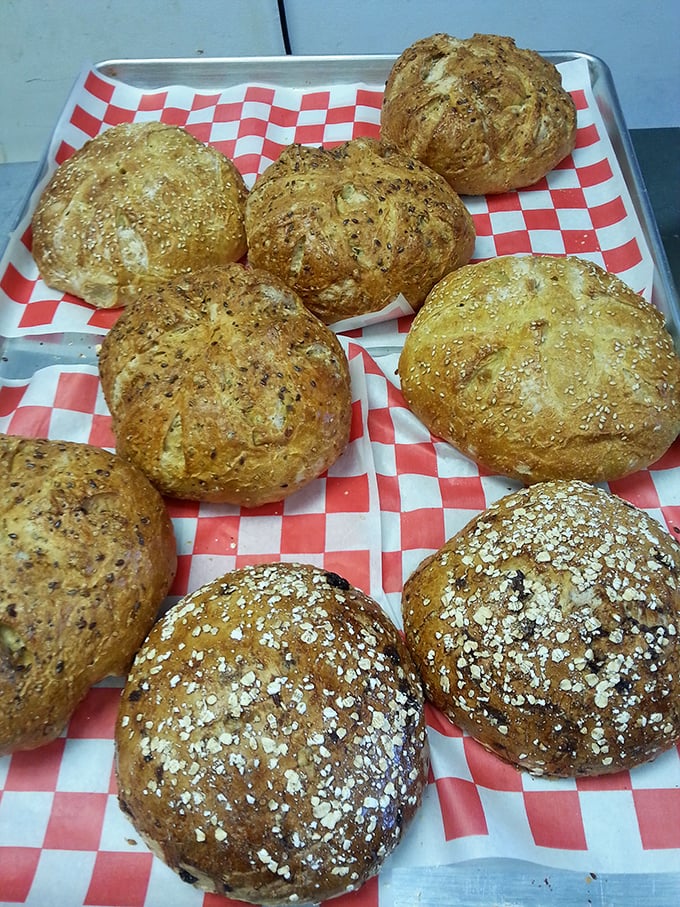 Fresh-baked bread rolls lined up like edible soldiers. These golden-brown beauties with their artisanal touches are ready for their supporting role.