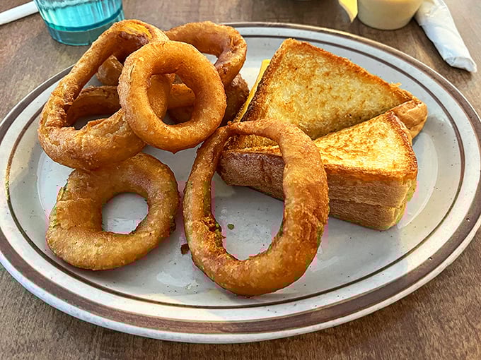 These onion rings aren't just side dishes – they're golden halos of happiness that crunch loud enough to turn heads.