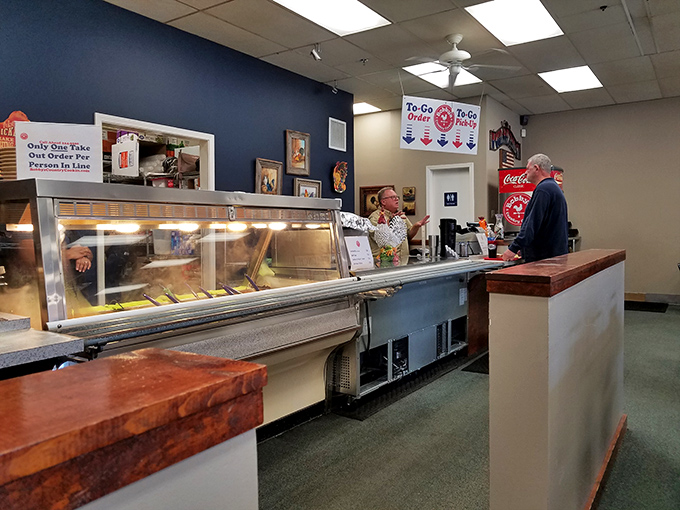 The serving line – where dreams come true and diet plans go to die, one scoop of mashed potatoes at a time.