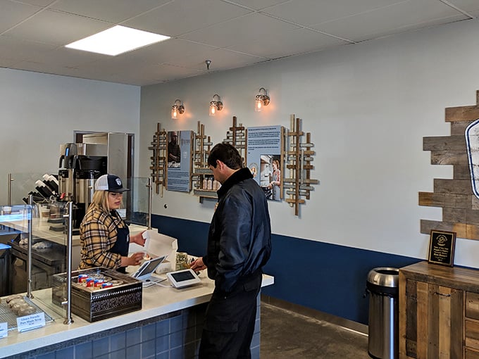 The moment of truth at the counter – where friendly faces guide you through the sweet dilemmas of donut selection.