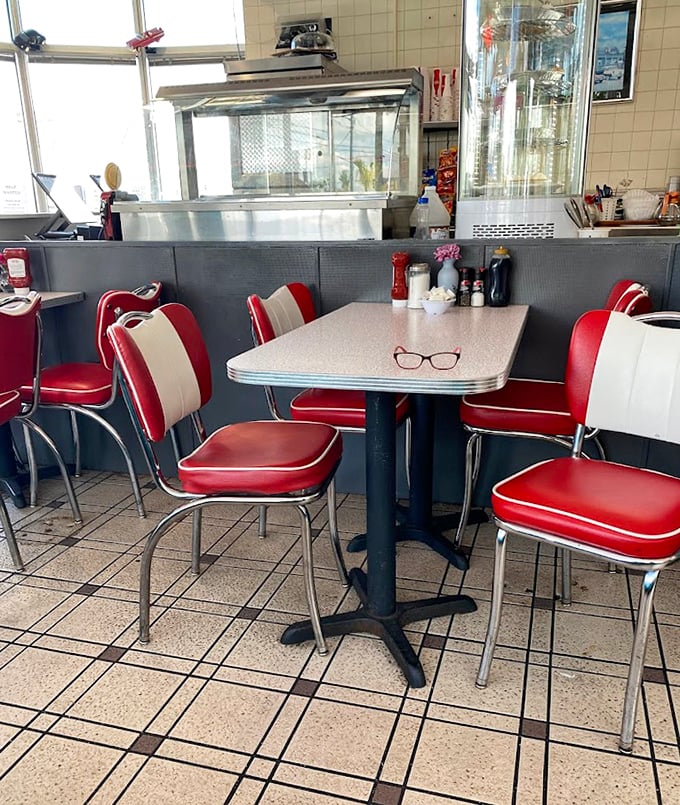 Those red and white chairs aren't just seating—they're time machines to when conversations happened face-to-face instead of screen-to-screen.