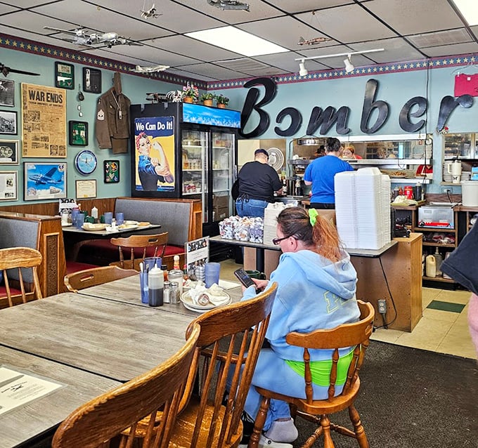 Another angle reveals more aviation memorabilia, because one wall of plane photos is never enough.