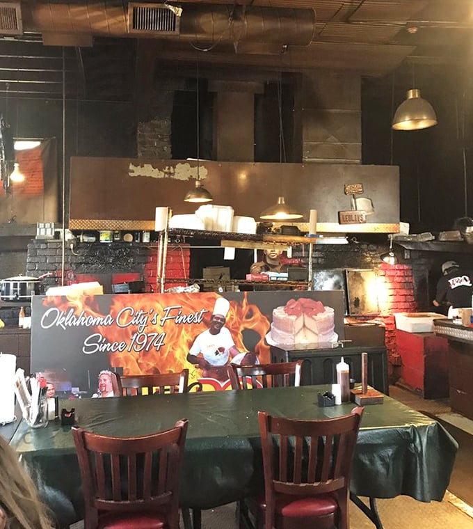 The open kitchen design lets you witness the barbecue magic happening—like dinner and a show rolled into one smoky experience.