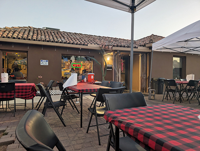 Red and black checkered tablecloths add a touch of casual charm to the outdoor seating area—Arizona dining at its most authentic.