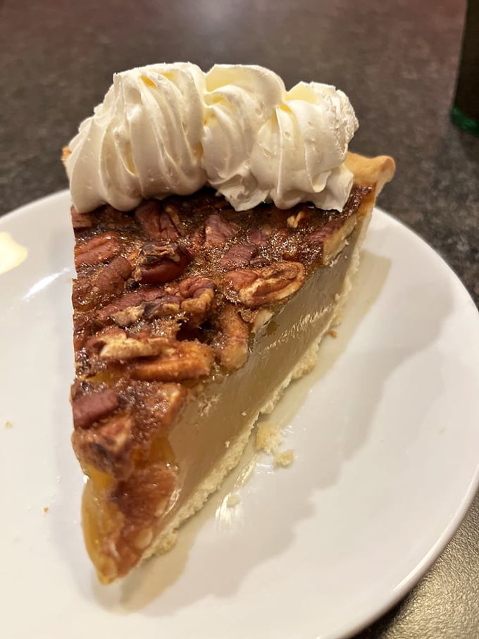 Pecan pie topped with whipped cream—the dessert equivalent of putting on your favorite sweater, if that sweater were made of butter and sugar.