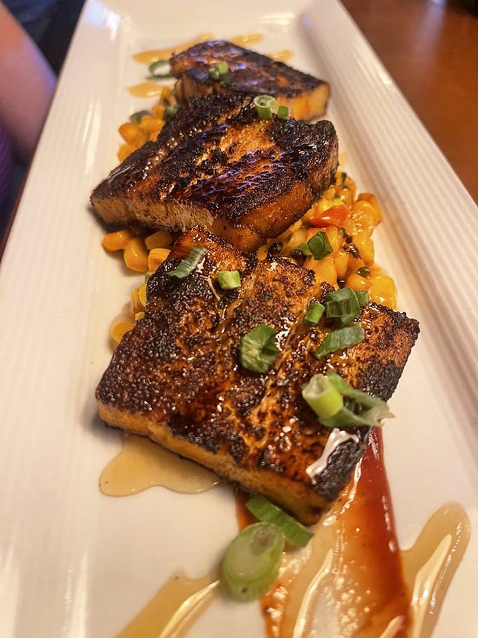 Pork belly that glistens with promise atop sweet corn. Each piece is a perfect trilogy of crispy exterior, melting fat, and tender meat—the holy trinity of pork perfection.