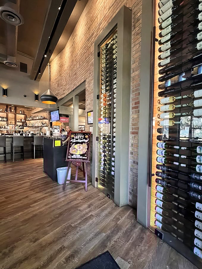 Wine displays that double as art installations line the walls. Brick, wood, and thoughtful lighting create an atmosphere of casual sophistication.