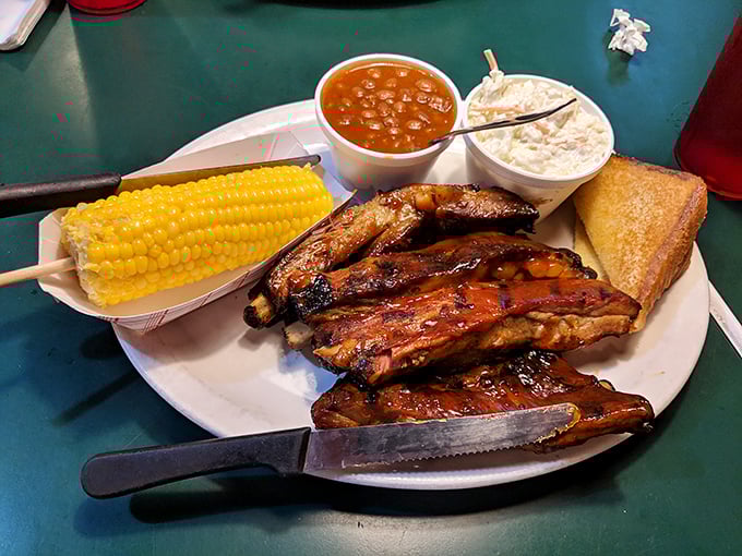 These ribs aren't just falling off the bone—they're practically jumping onto your fork, accompanied by corn that's still dreaming of summer.