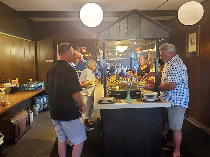 The salad bar—that endangered species of American dining—lives gloriously at Spillway Lodge. Patrons gather around it like it's a watering hole in the Serengeti of sides.