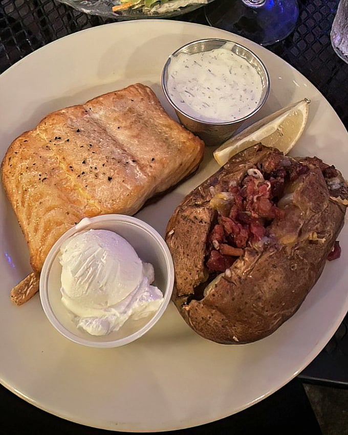Salmon and a loaded baked potato—the dynamic duo of supper club entrées, fighting the good fight against hunger one plate at a time.