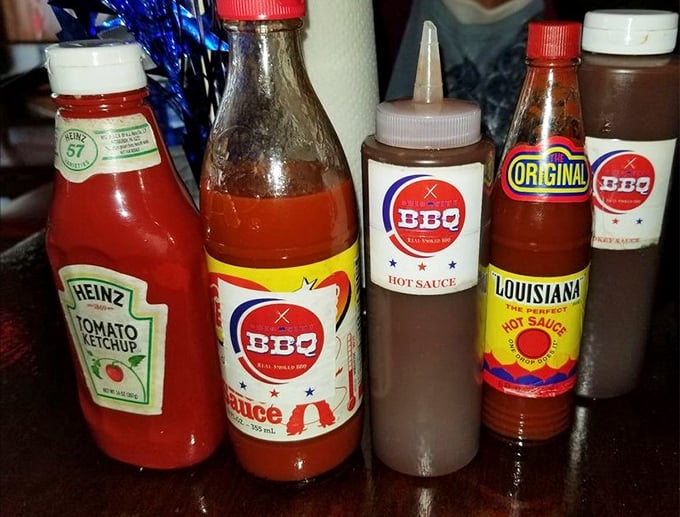 The sauce lineup – from classic to hot – stands ready for duty. These bottles are the supporting actors that help the meat stars shine.