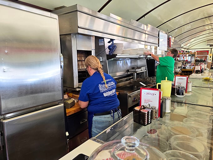 Skilled hands at work—where breakfast isn't just a meal, it's a choreographed performance that's been perfected over decades.