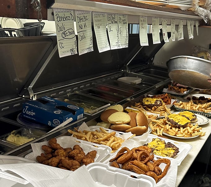 The kitchen pass—where culinary dreams come true. Those handwritten tickets are like love notes to your stomach.