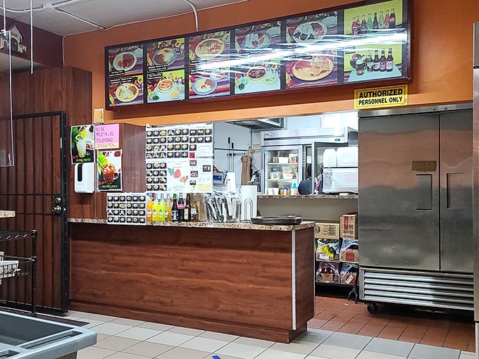 Behind the counter, where magic begins – a glimpse into the organized chaos that somehow produces plate after plate of consistent deliciousness.