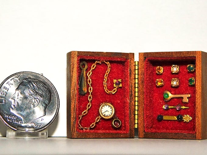 A miniature jewelry box with treasures smaller than a dime—the watchmaker who crafted that pocket watch deserves a medal for steady hands.