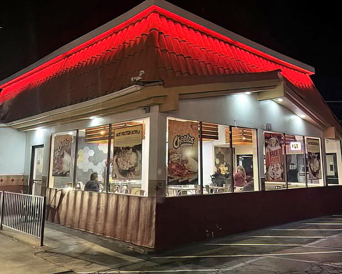 The snack bar glows like a beacon in the night, its red-trimmed roof guiding hungry moviegoers toward buttery popcorn paradise.