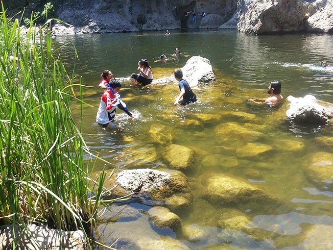 Sun-warmed water between ancient cliffs transforms ordinary swimming into the kind of refreshing escape that justifies the hike in.