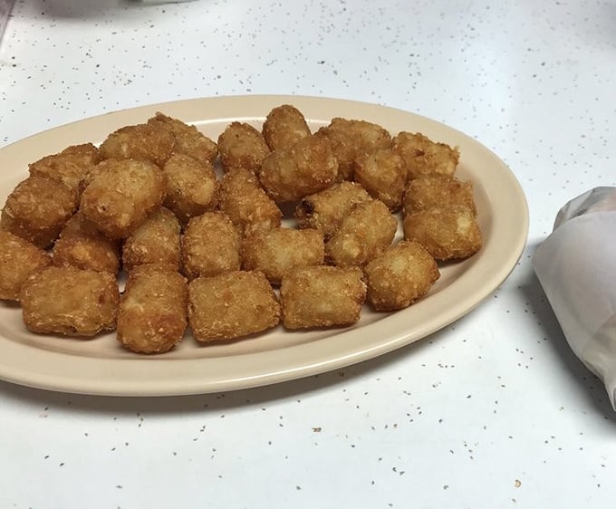 Golden tater tots that achieve the impossible: perfectly crisp exteriors giving way to fluffy potato interiors—the unsung heroes of any proper Southern plate.