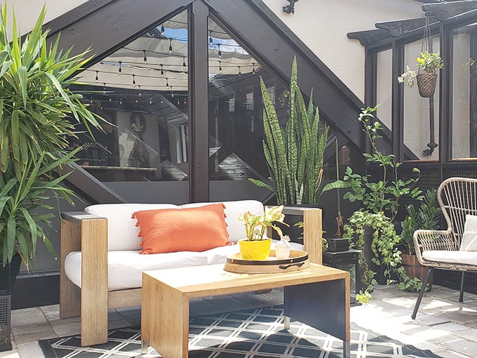 This outdoor lounge area feels like the sophisticated patio of your dreams—if your dreams included perfect lighting and designer furniture.