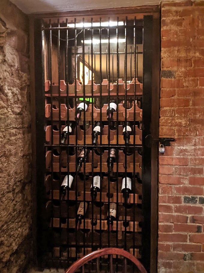 The wine cellar's jail-cell aesthetic isn't ironic—it's historic! These bottles are serving delicious time until you order them.