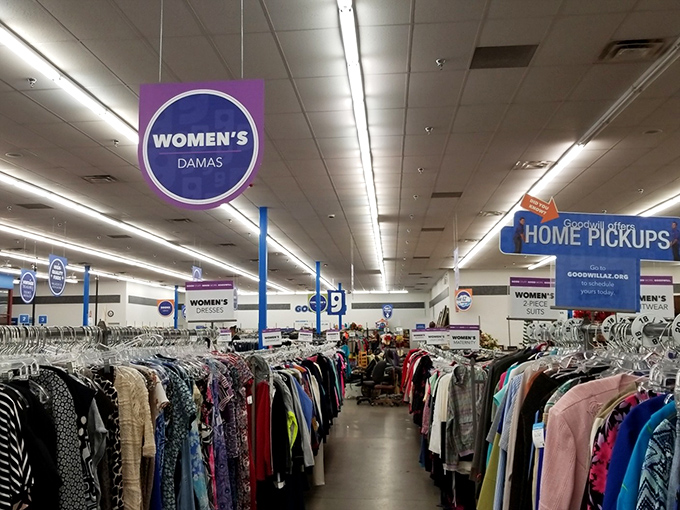Under signs that guide but never rush, women's fashion awaits—dresses, blouses, and jackets organized with department store precision.