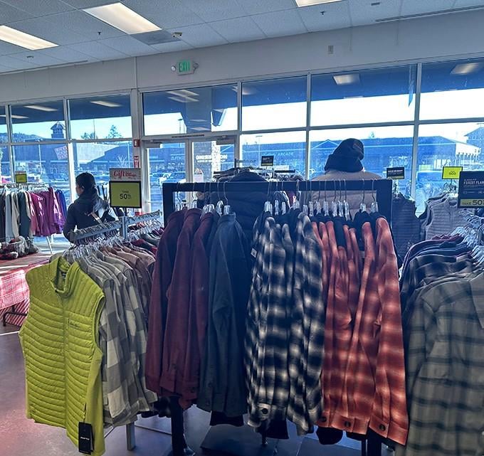 Flannel shirts hang in organized rows, ready to outfit the entire Pacific Northwest in cozy style.