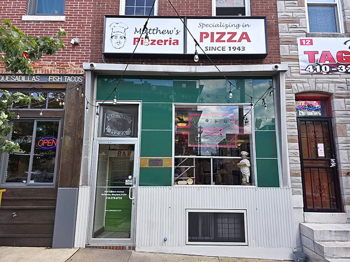 The green and white façade of Matthew's hints at the old-school pizza experience waiting inside.