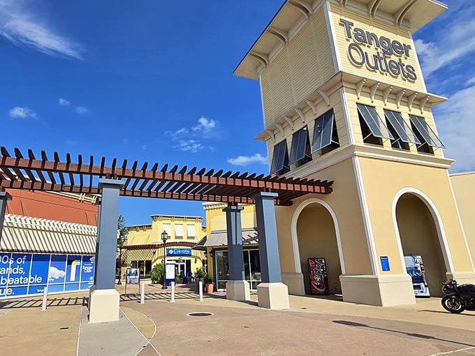 Yellow towers stand sentinel over bargain paradise, where Texas City's outlet magic unfolds beneath endless blue skies.
