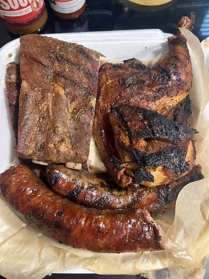 The holy trinity of barbecue—ribs, chicken, and sausage sharing a plate like old friends at a reunion. No favorites here, just excellence.