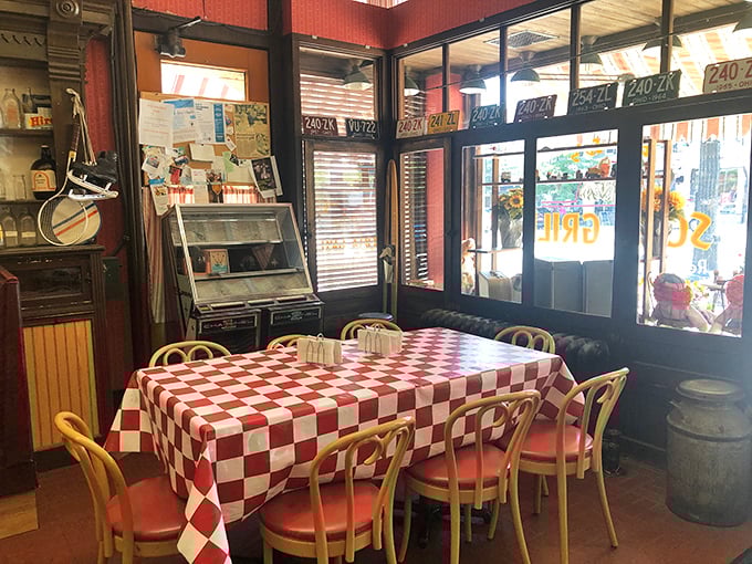 Classic diner seating with a red-checkered tablecloth that practically whispers, "Sit down, take your time, there's no rush here."