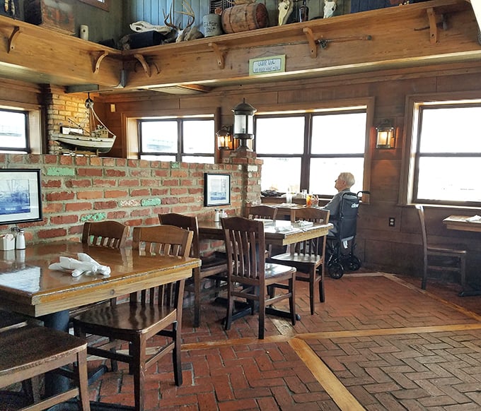 Sunlight streams through windows framing waterfront views – the perfect backdrop for seafood that was likely swimming nearby just hours ago.