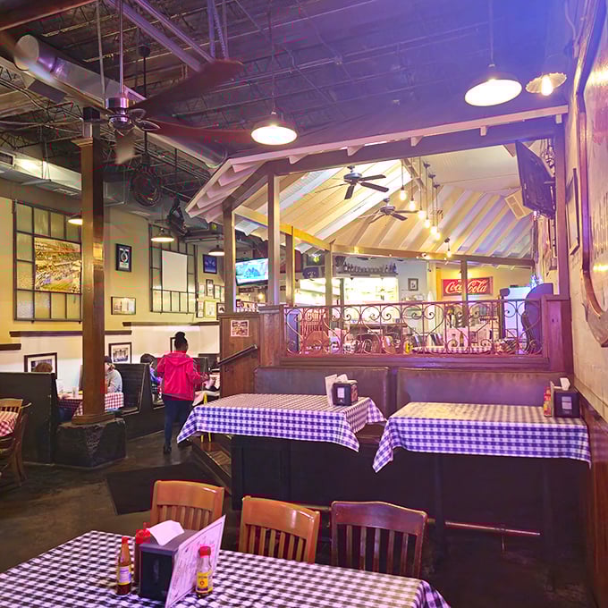 Tiered seating creates chicken-eating neighborhoods within the restaurant. The wrought iron railings separate the dining areas like delicious little chicken districts.