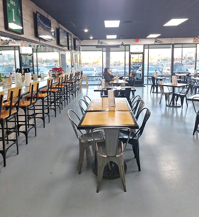 The dining area balances efficiency with comfort – metal chairs and wooden tables creating a space where the food, not the furniture, takes center stage.