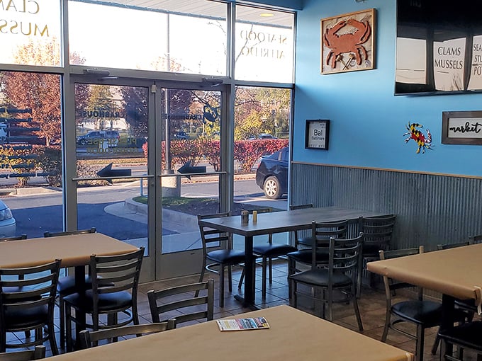 Simple tables, bright windows, and that signature blue wall—the dining area promises zero pretension and 100% focus on the food.