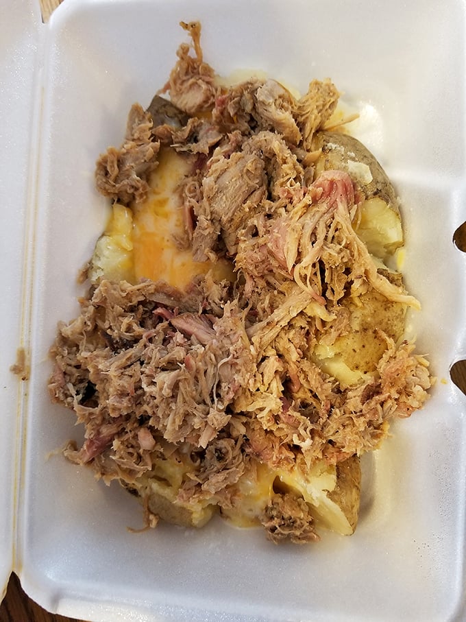 The loaded BBQ potato – where a humble spud transforms into a meat-topped masterpiece that requires both a fork and a commitment.