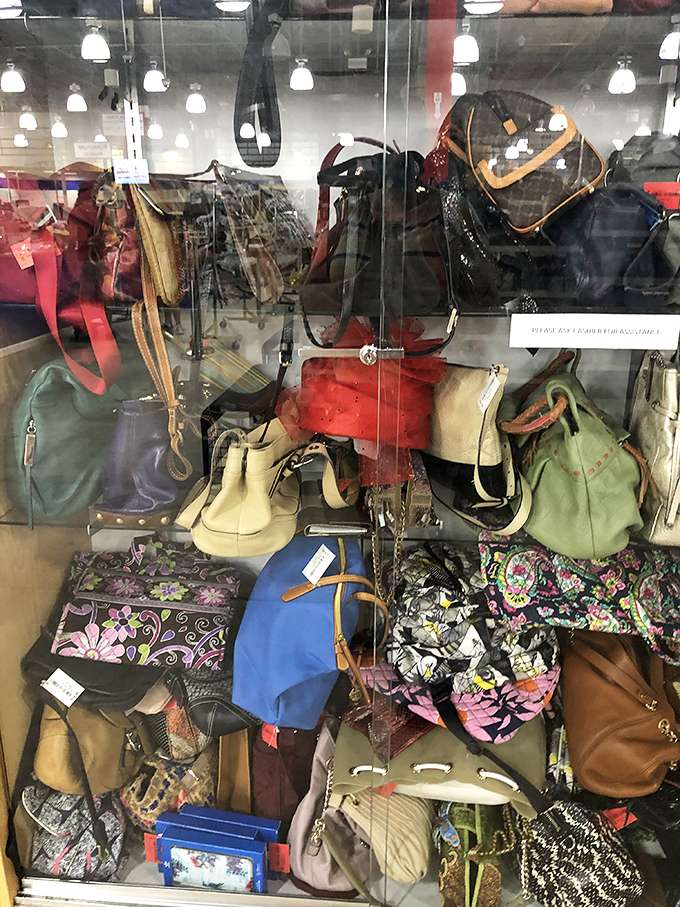 Handbags of every color and pattern huddle together behind glass, from designer names to quirky conversation starters—all waiting for new shoulders.