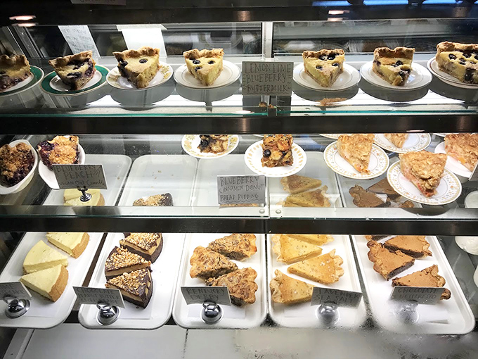 A dessert case that turns willpower into a theoretical concept—each slice a reason to skip the beach diet for one more day.