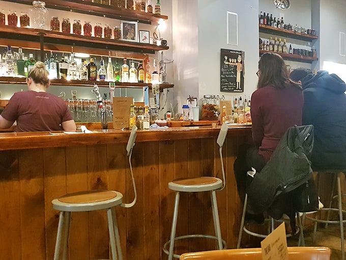 The bar proves The Roost isn't just a morning affair. Those wooden stools have witnessed many a brunch cocktail turning ordinary days into celebrations. 