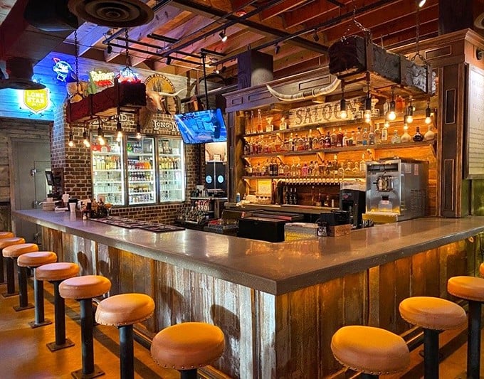 The saloon bar—where bourbon flows, stories grow, and the wooden stools have supported countless happy customers contemplating "just one more."