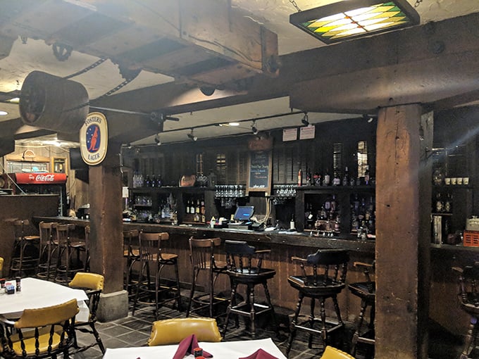 The bar area maintains the building's industrial charm—where wooden beams and exposed pipes create the perfect backdrop for craft cocktails.