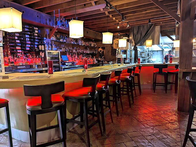 The bar glows with amber promise—a place where strangers become friends and friends become slightly louder friends.