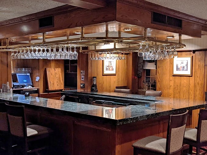 A bar where the glasses hang like crystal stalactites, promising libations that have been perfected over decades rather than invented last Tuesday.