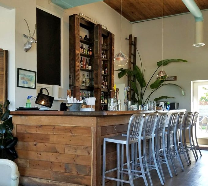 The bar isn't just functional—it's a wooden masterpiece where craft drinks are poured and food envy spreads faster than gossip.