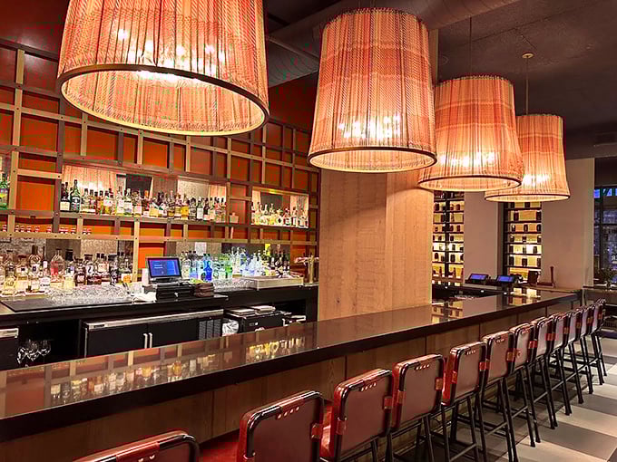 The bar where liquid alchemy happens beneath warm lamplight. Those stools have heard some stories – and are ready for yours.